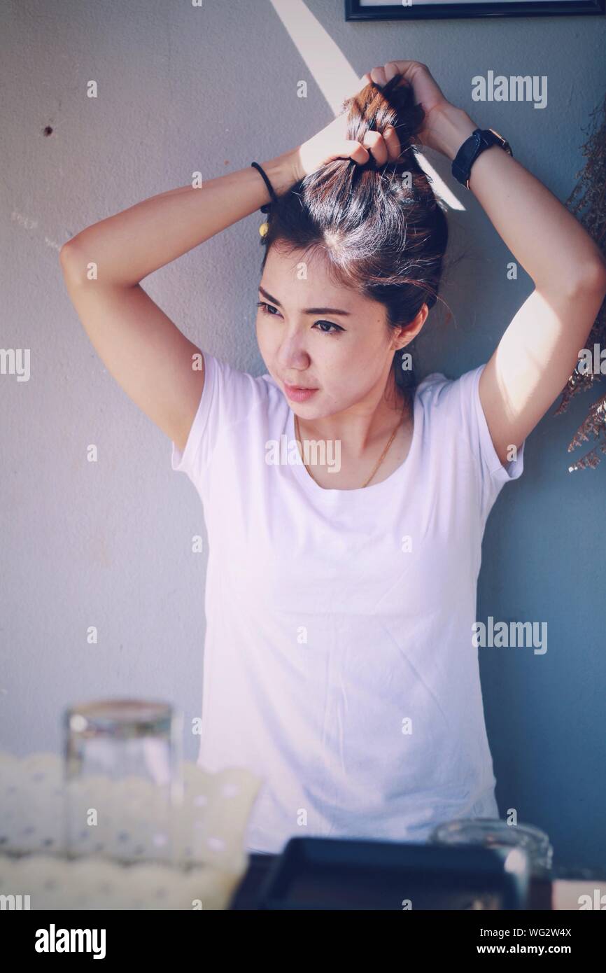 One woman putting hair hi-res stock photography and images - Alamy