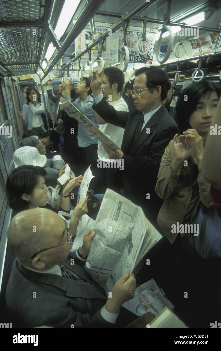 Reading the newspaper subway hi-res stock photography and images - Alamy