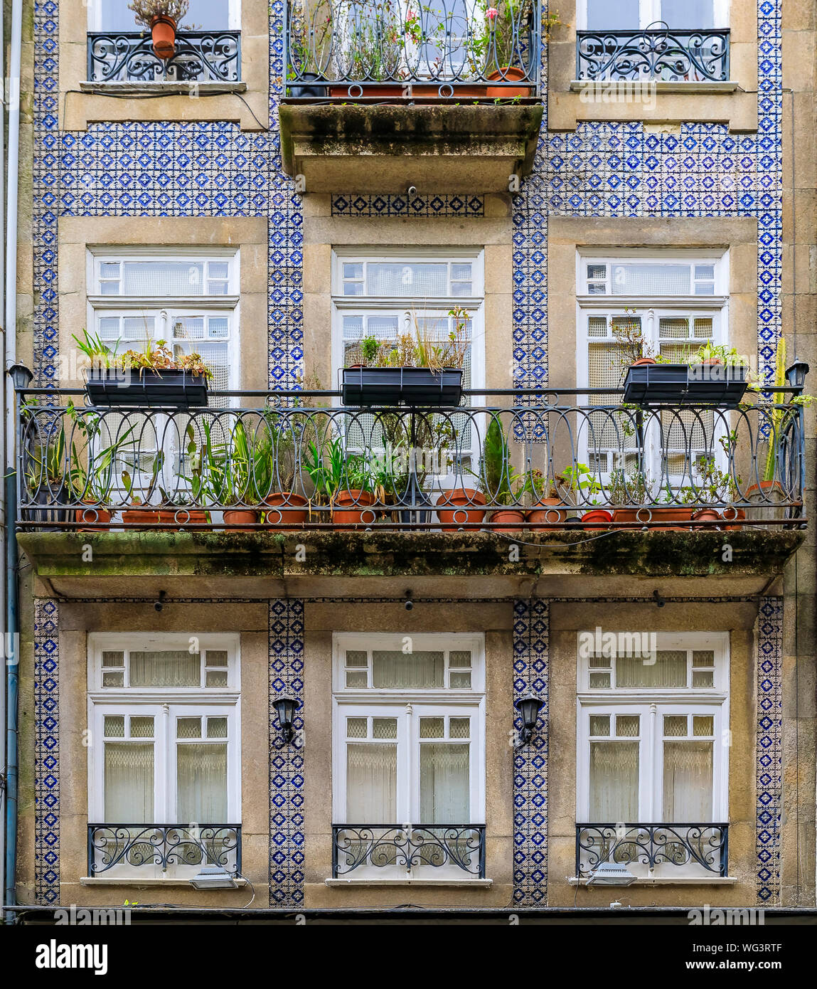 Facades of traditional houses decorated with ornate Portuguese azulejo ...
