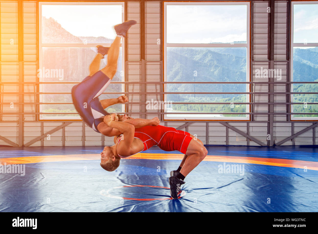 The concept of fair wrestling. Two greco-roman wrestlers in red and ...