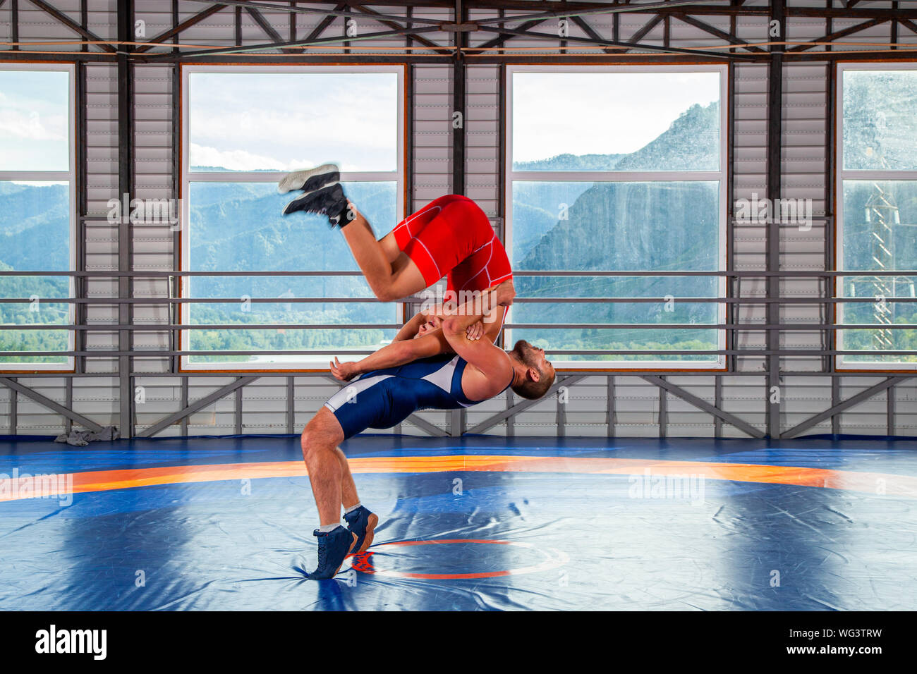 The concept of fair wrestling. Two greco-roman wrestlers in red and ...