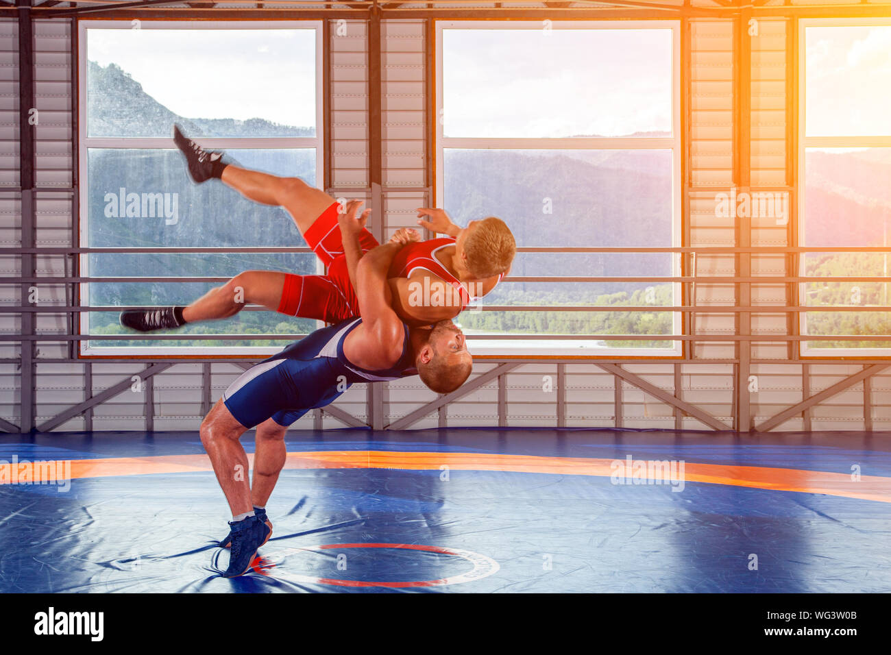 The concept of fair wrestling. Two greco-roman wrestlers in red and ...