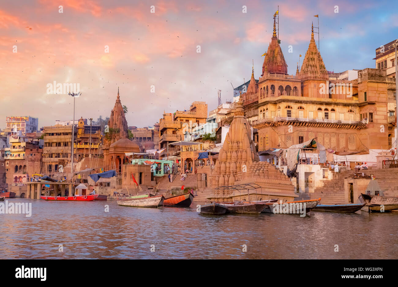 Varanasi historic city architecture at sunset with view of Ganges river ...