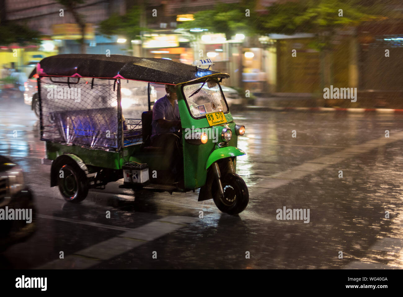 Man Driving Tuk-tuk On Road At Night During Rain Stock Photo - Alamy