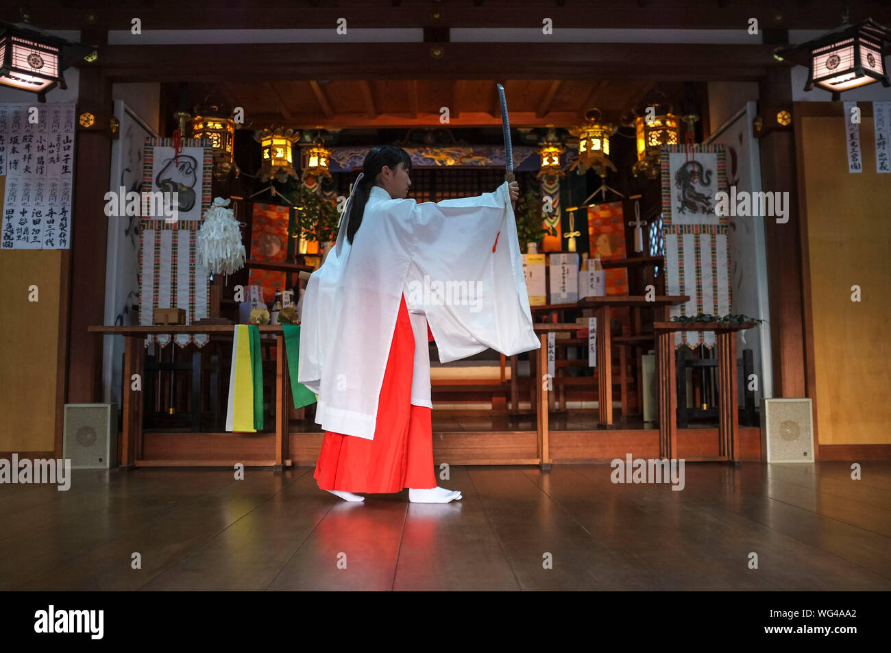A Miko is performing a traditional dance at the Natsu Matsuri, summer ...