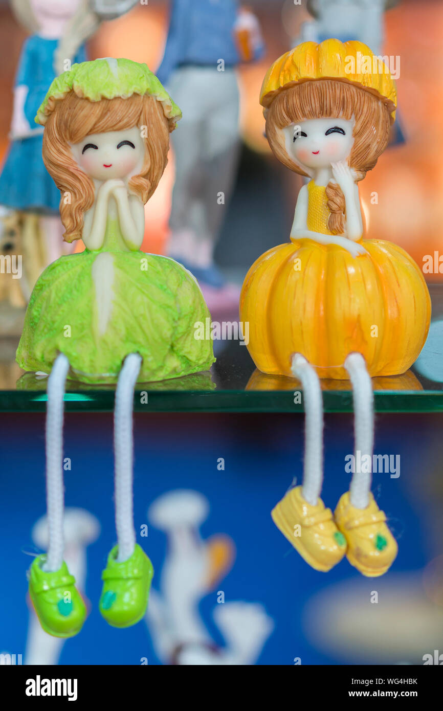 Two little dolls in a shop window. vertical photo Stock Photo - Alamy
