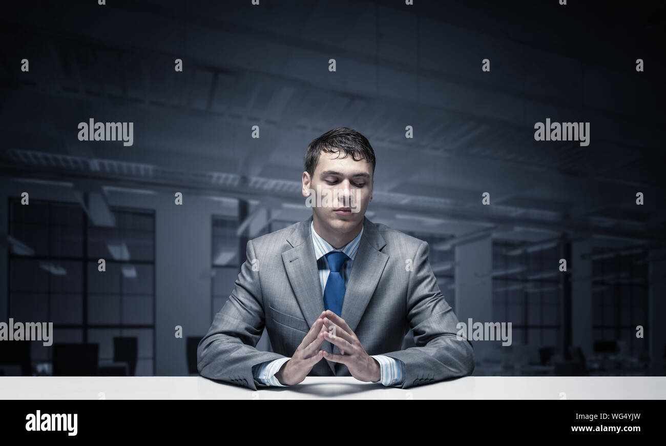 Young man folded hands and having serious and calm face. Businessman ...