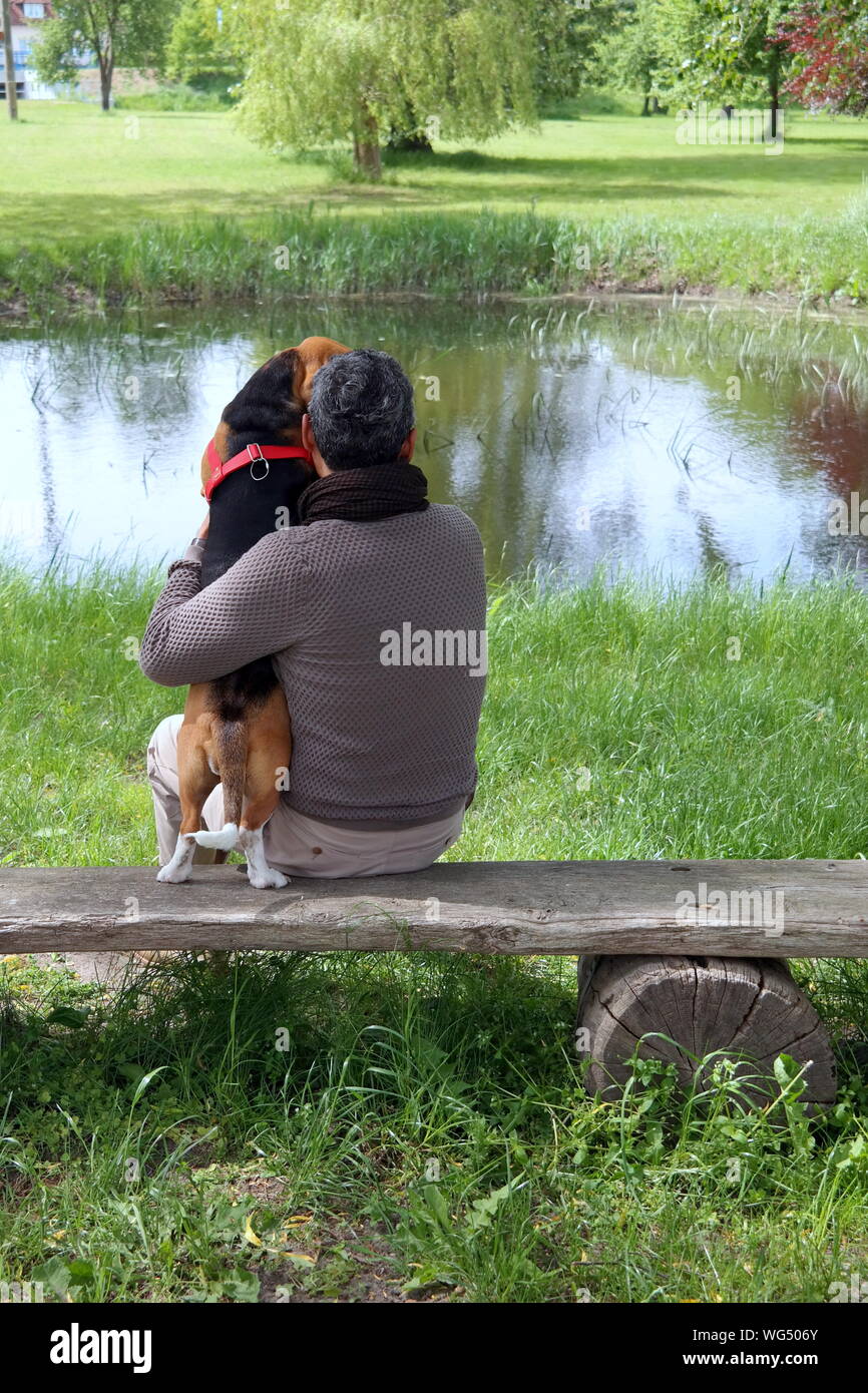 Man Dog Sitting On Grass High Resolution Stock Photography and Images ...