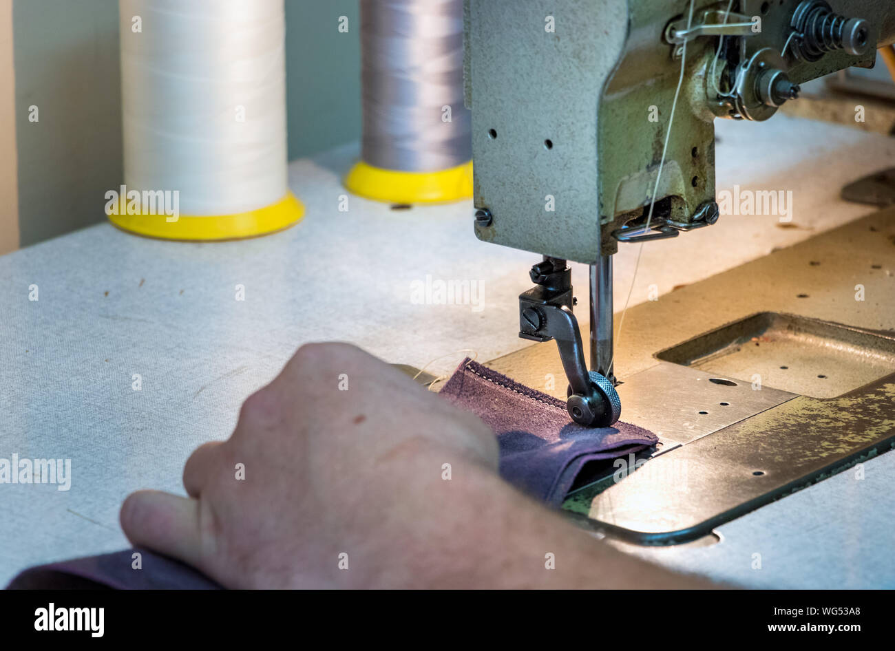 A male shoemaker hands, sewing leather with an old sewing machine Stock ...
