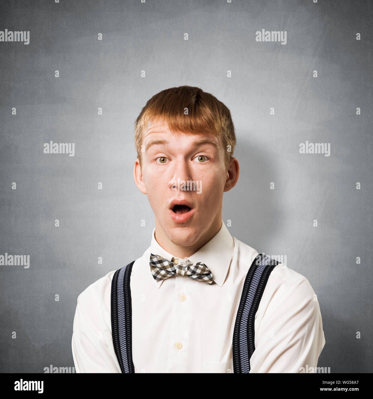 Stupefied teenager with mouth opened. Emotional redhead boy has shocked ...
