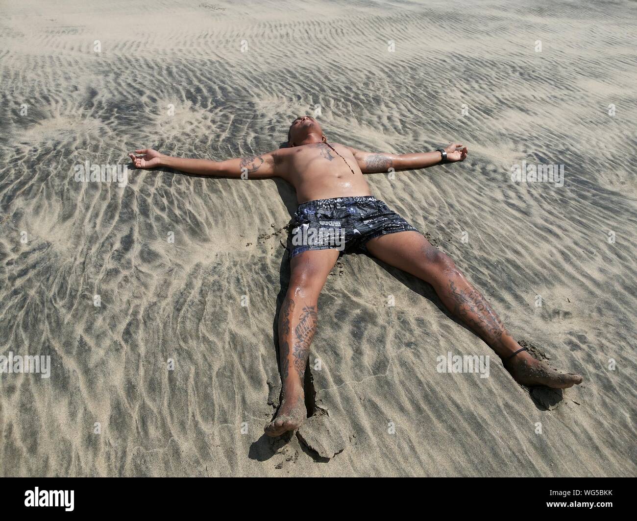 Man resting on sand hi-res stock photography and images - Alamy