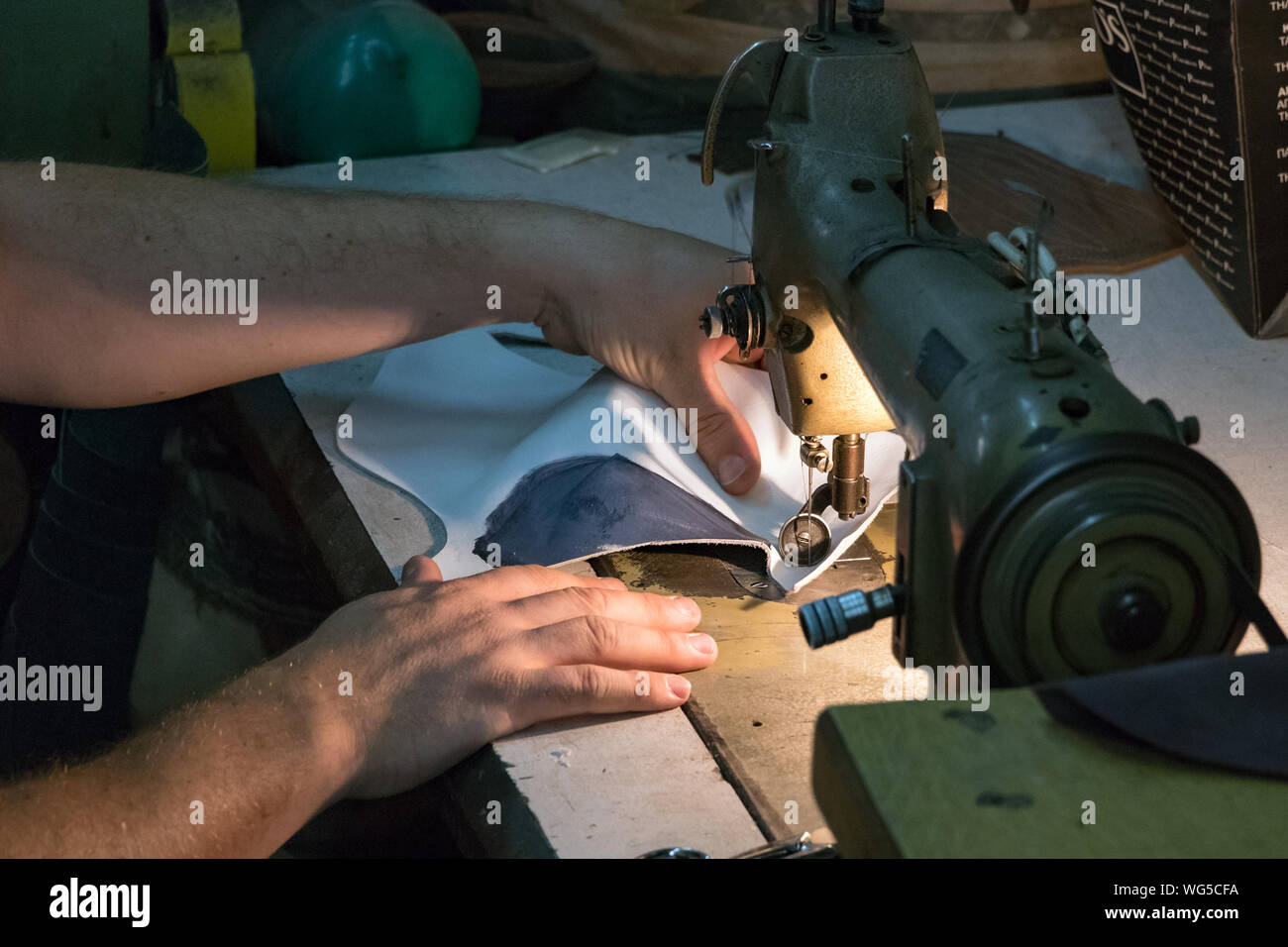 A male shoemaker hands, sewing leather with an old sewing machine Stock ...