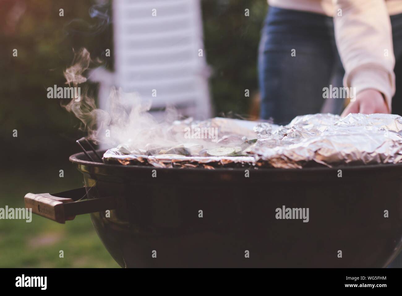Person at barbecue hi-res stock photography and images - Alamy