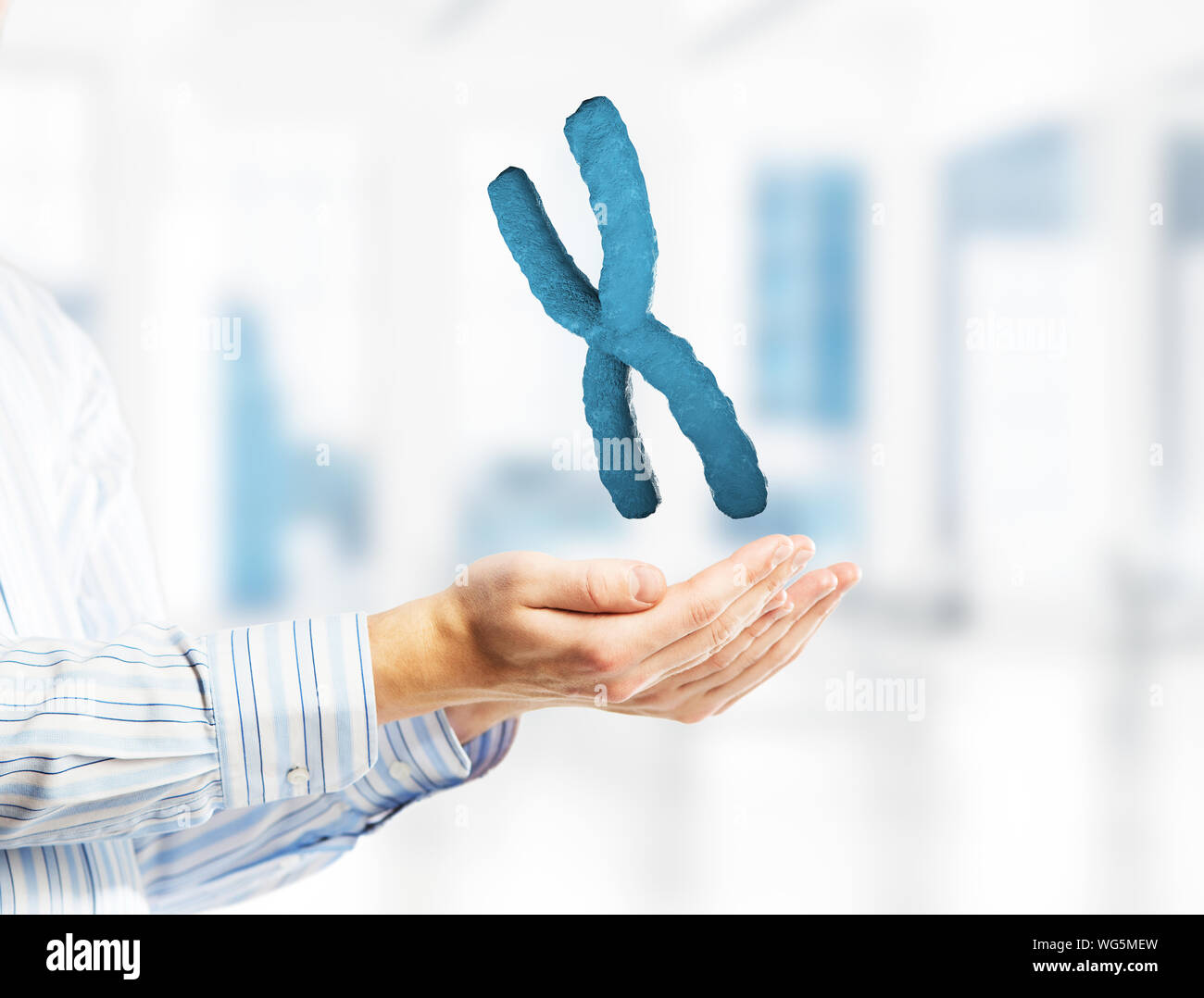 Close of human hand showing DNA molecule on office interior background ...
