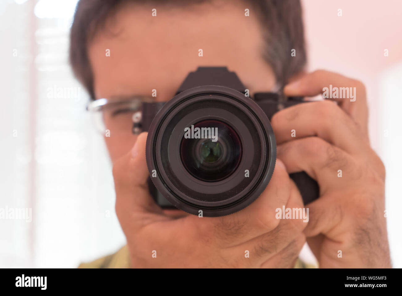 Portrait of man taking photography with mirrorless camera. Hold the ...