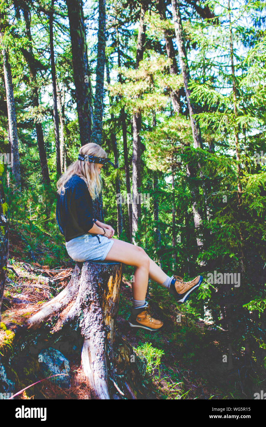 Woman Sitting On Tree Stump High Resolution Stock Photography and ...
