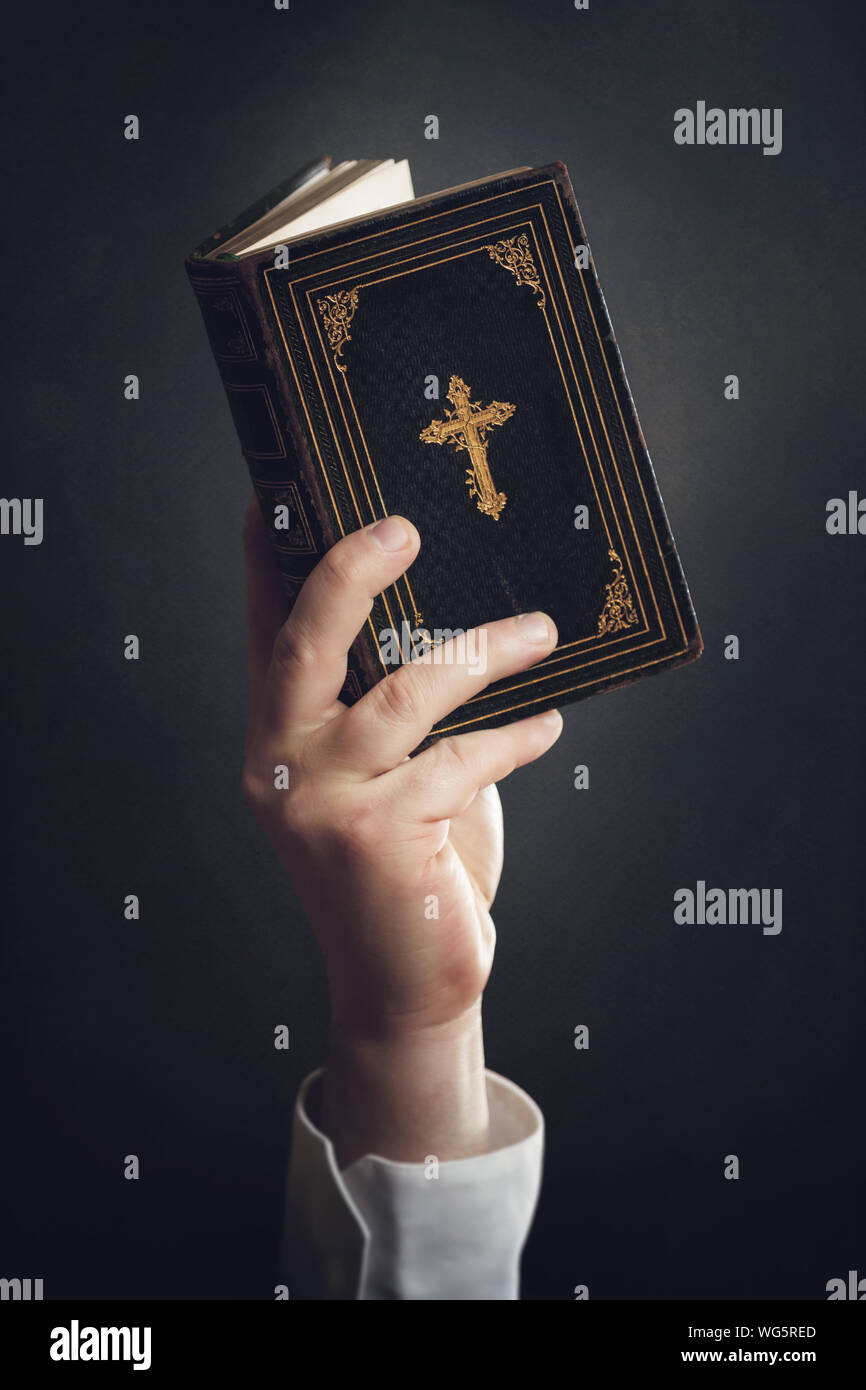 Man holding up bible hi-res stock photography and images - Alamy