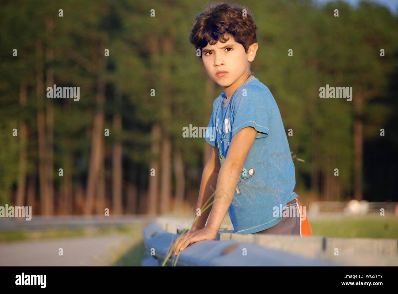 Boy on fence hi-res stock photography and images - Alamy