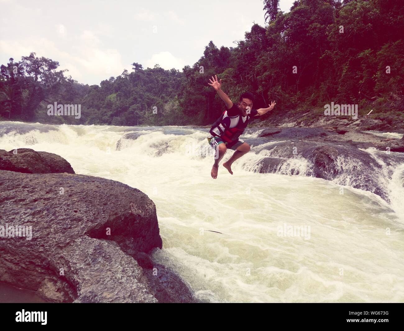 Man jumping over river hi-res stock photography and images - Alamy