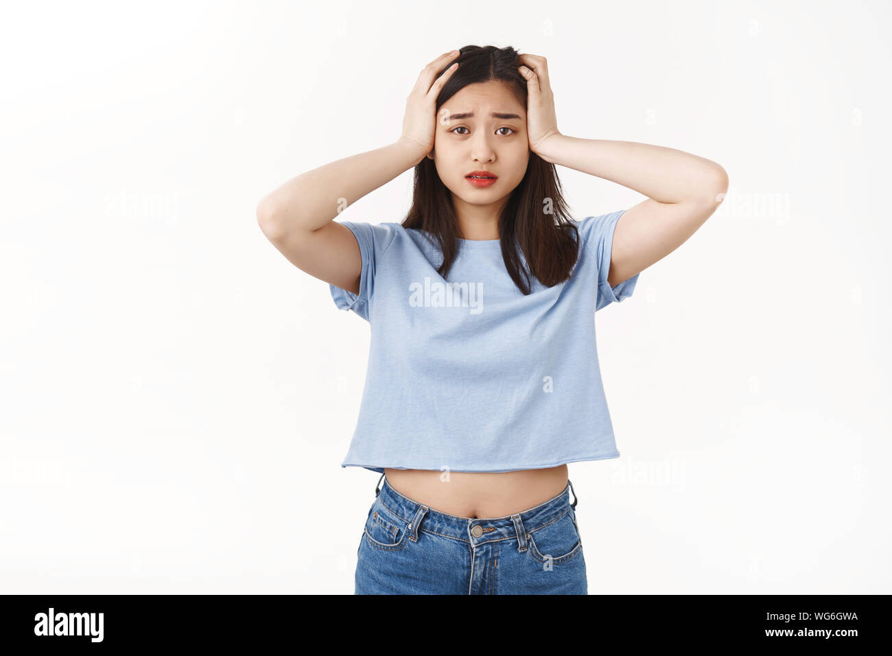 Gosh what should I do. Perplexed panicking young tired asian female ...