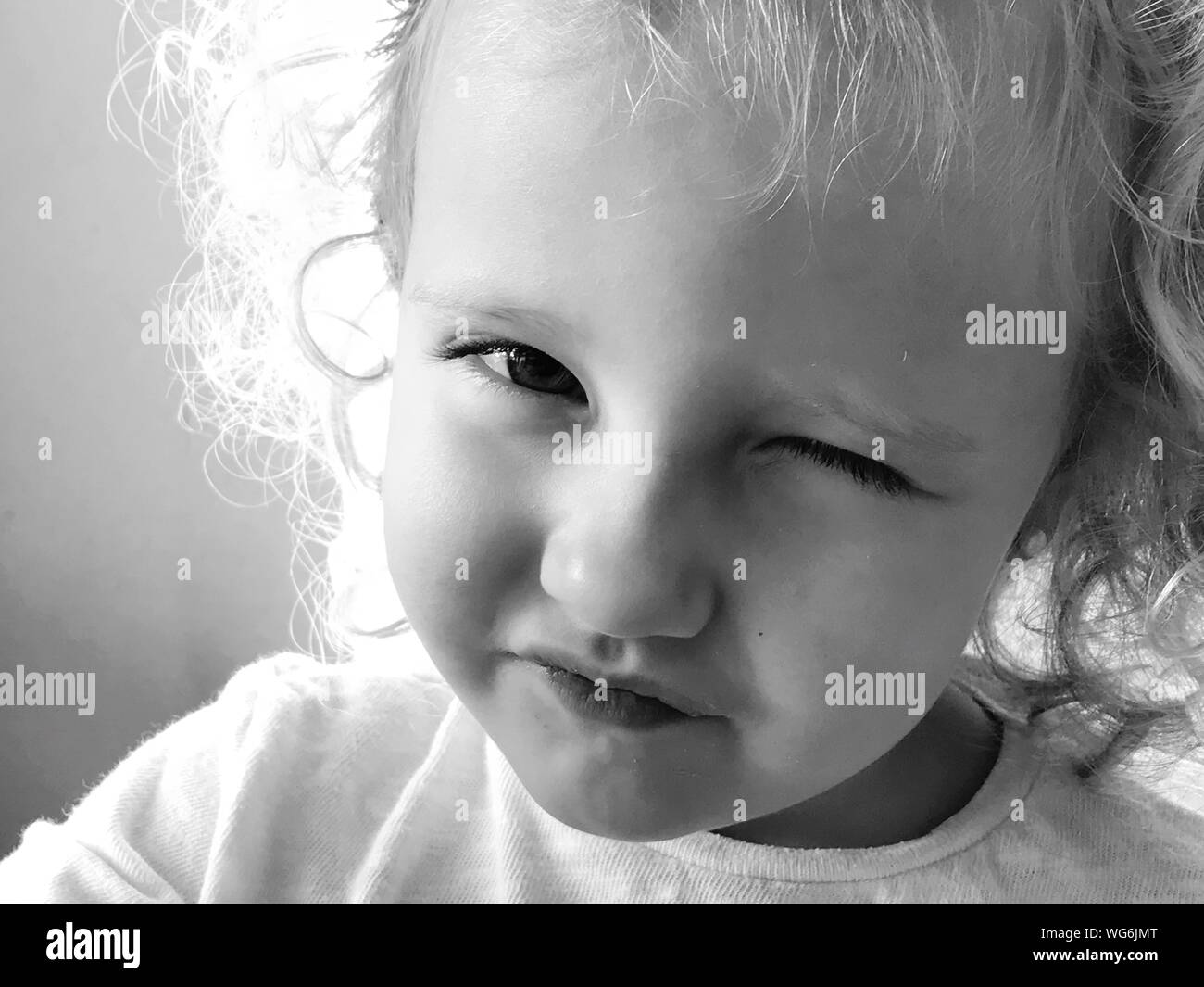 Girl winking close up hi-res stock photography and images - Alamy