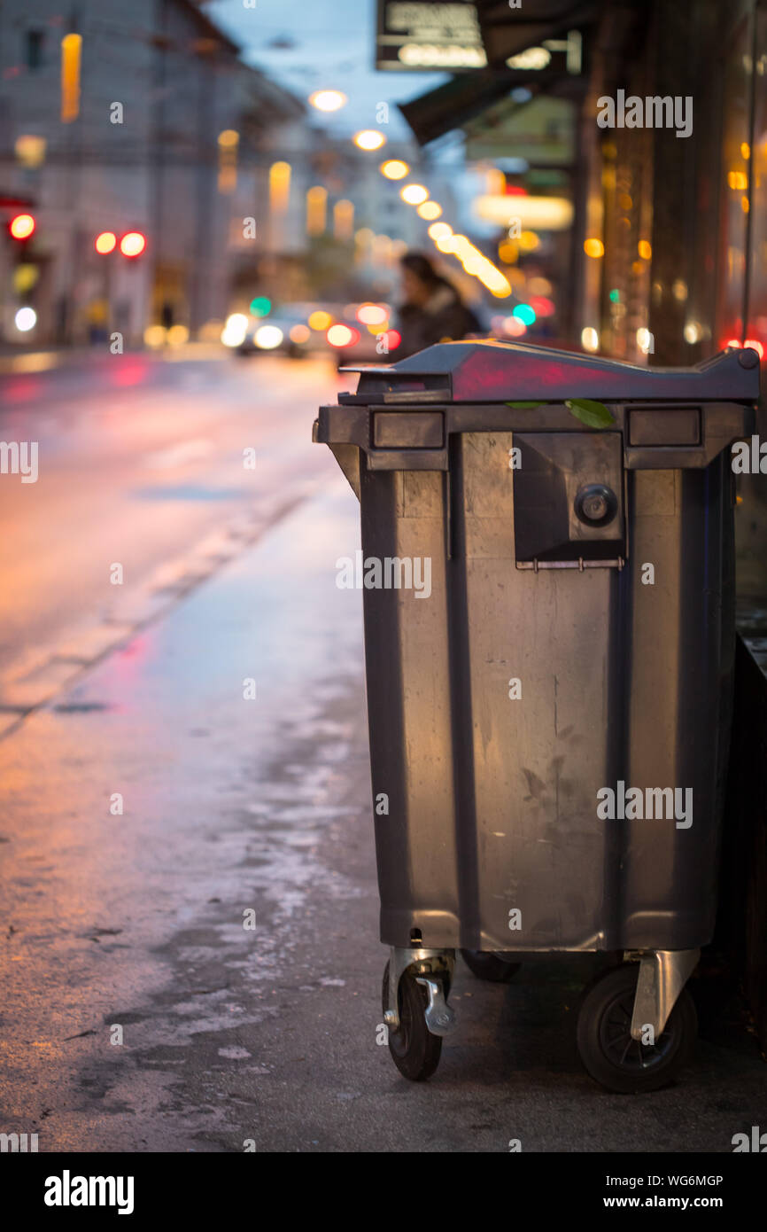 Urban street life with garbage container and street lights Stock Photo ...
