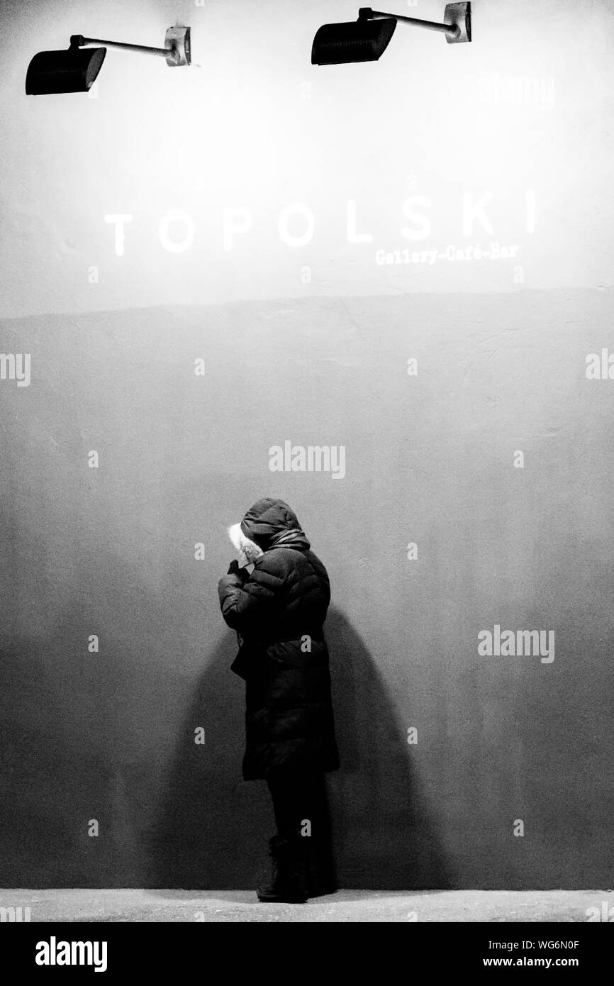 Full Length Of Person Standing Against Wall At Night Stock Photo - Alamy