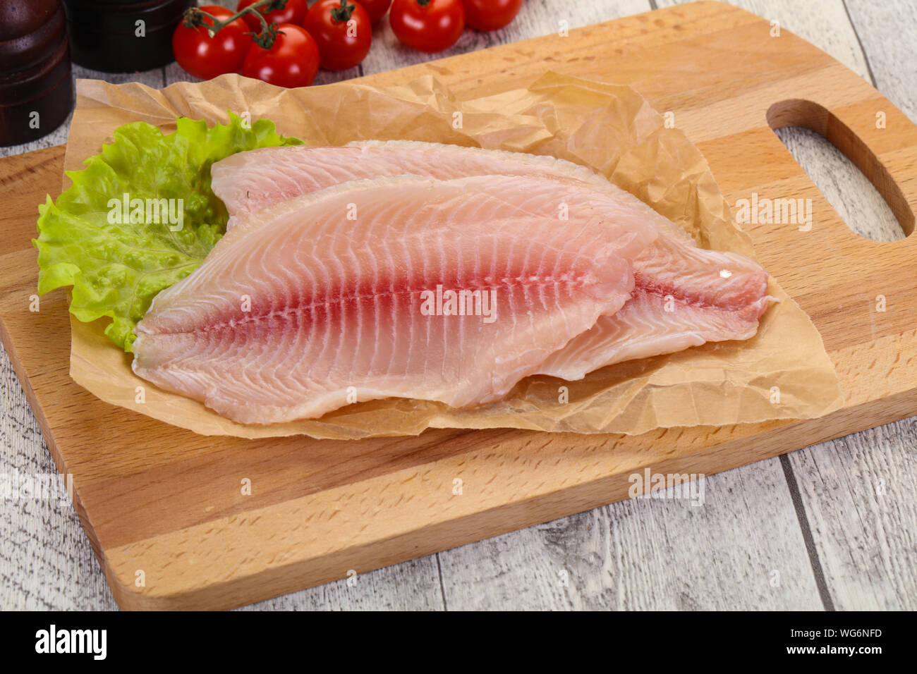 Raw tilapia fish ready for cooking Stock Photo - Alamy