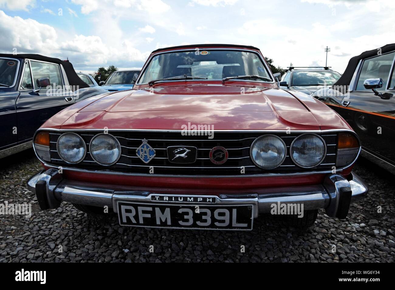 A front grille view of a 1971 Triumph Stag sports car in a line up of ...