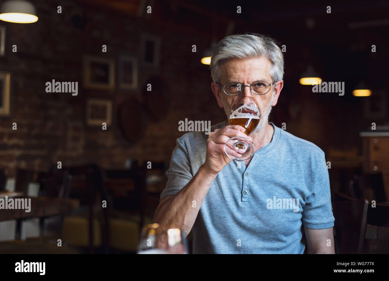 Man drinking alone in bar hi-res stock photography and images - Alamy