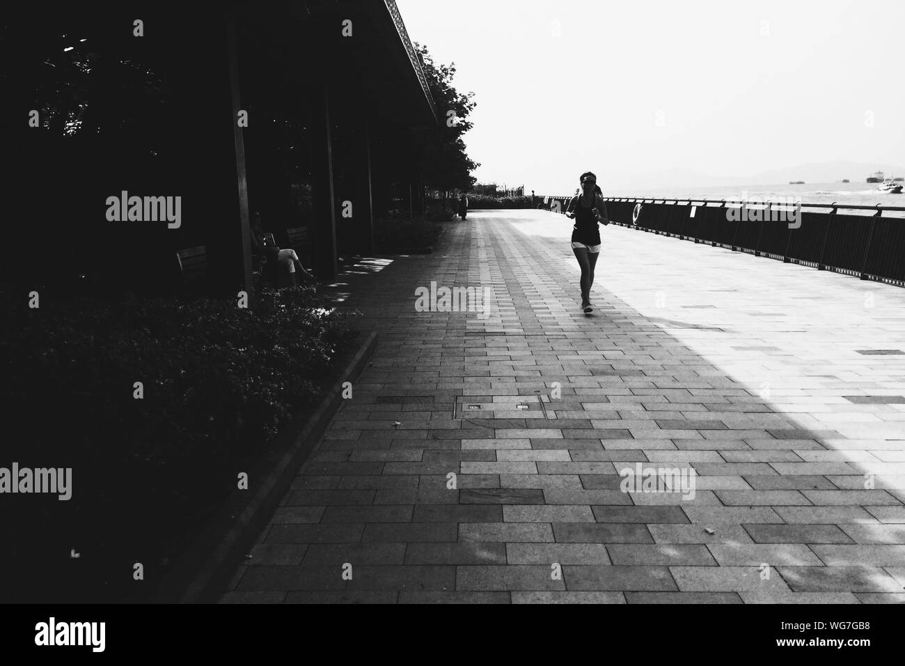 Full Length Of Woman Walking On Road Stock Photo - Alamy