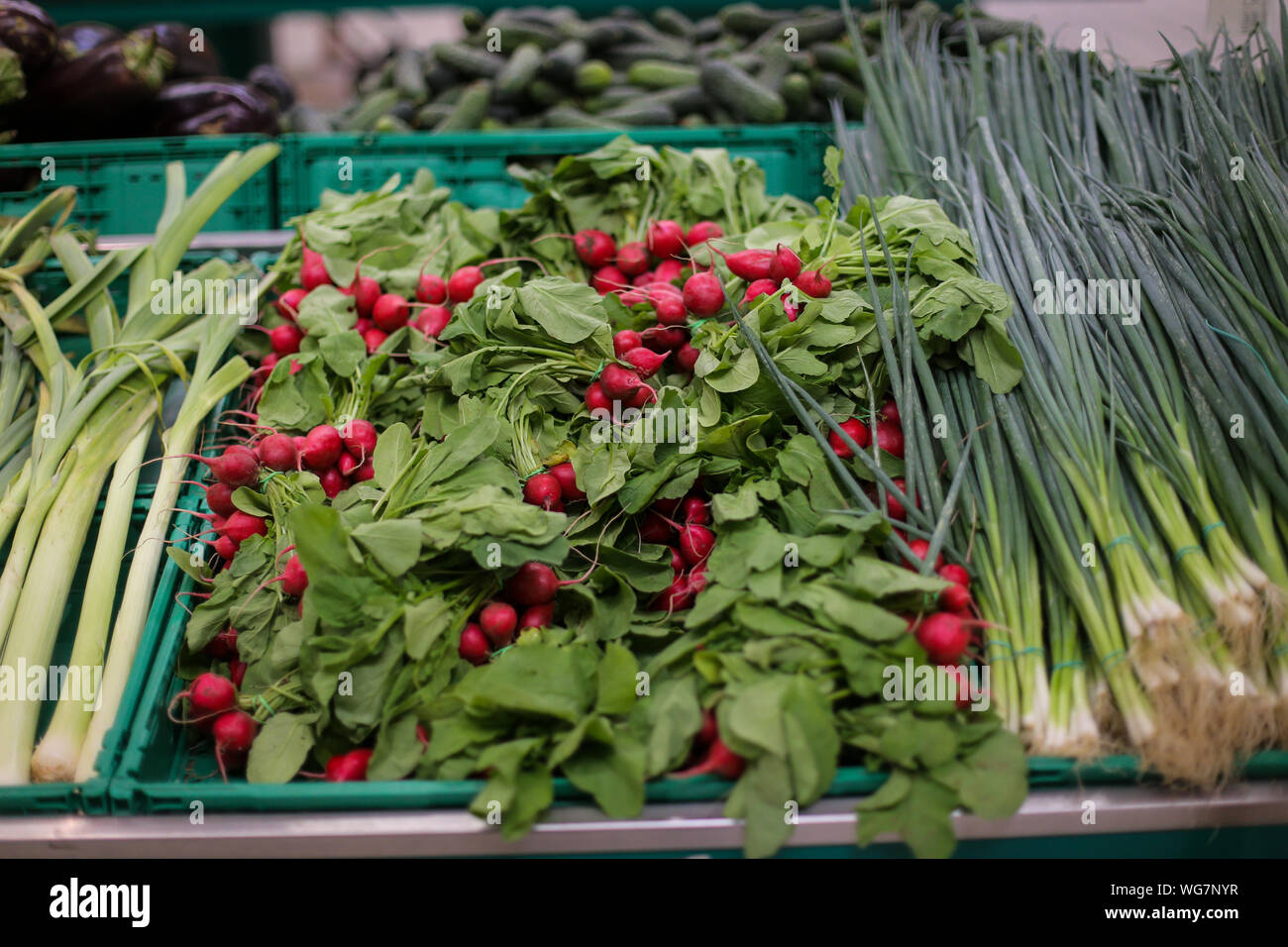 Radish and spring onions on the fruits and vegetables aisle in a store ...