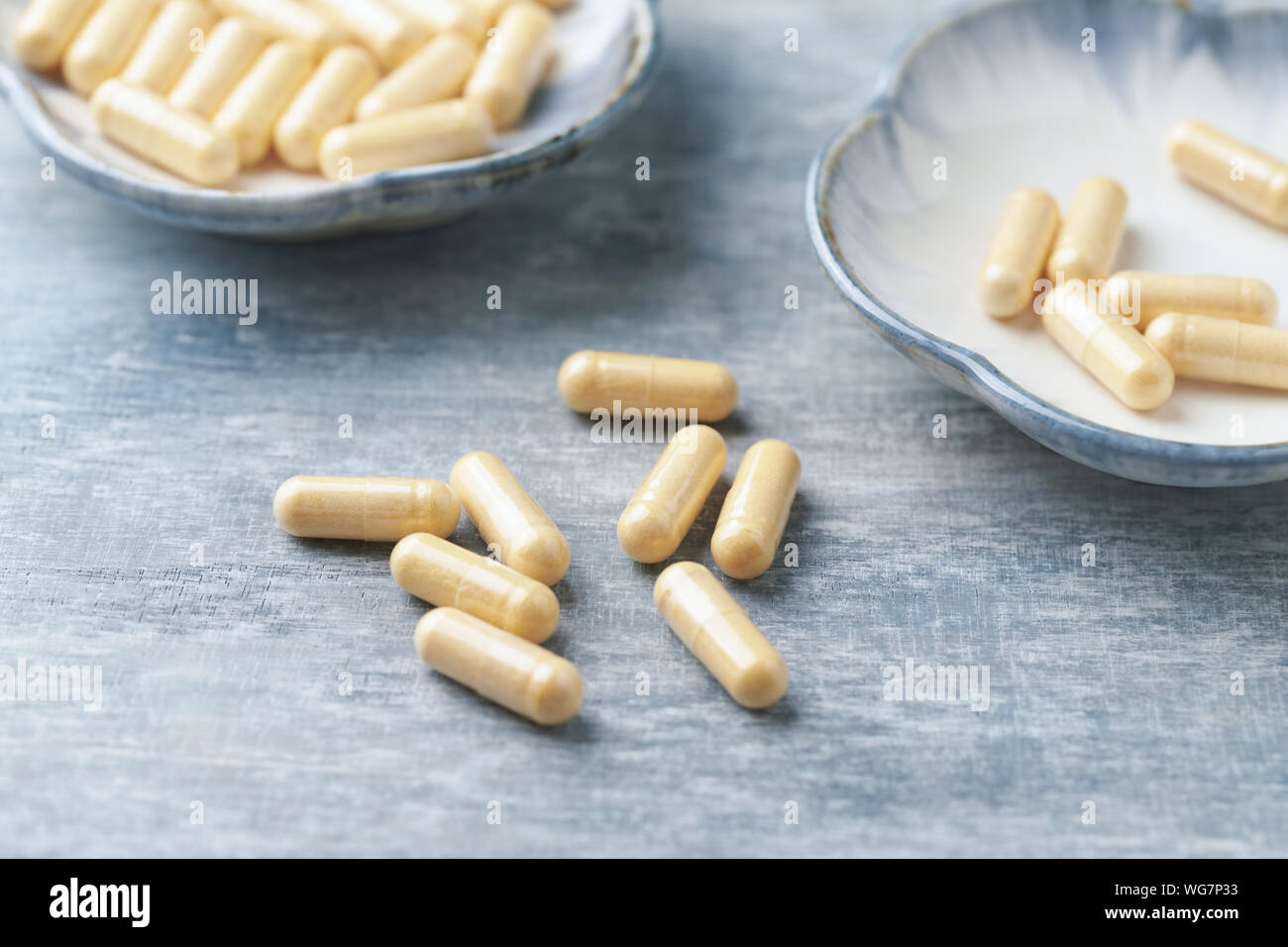 Coenzyme Q10 capsules. Dietary supplements. Rustic wooden background ...