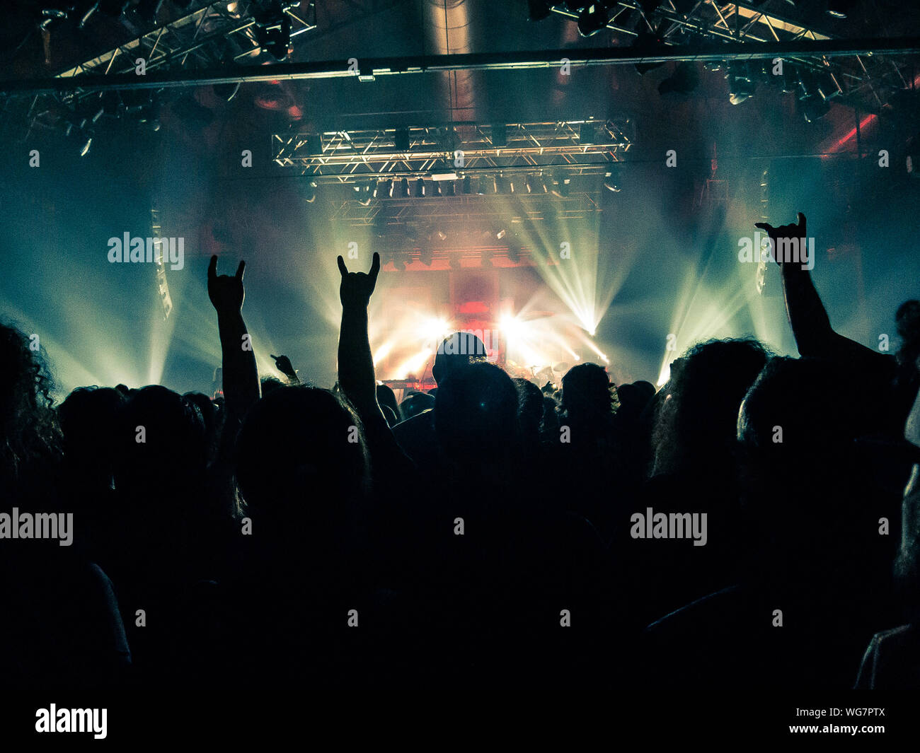 Concert crowd clapping in front of a bright stage Stock Photo - Alamy