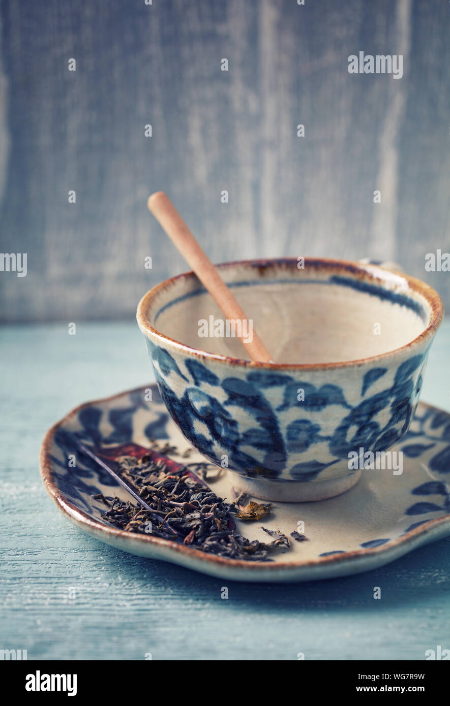 Empty Ceramic Tea Cup and Green Tea Leaves. Symbolic image. Asian ...