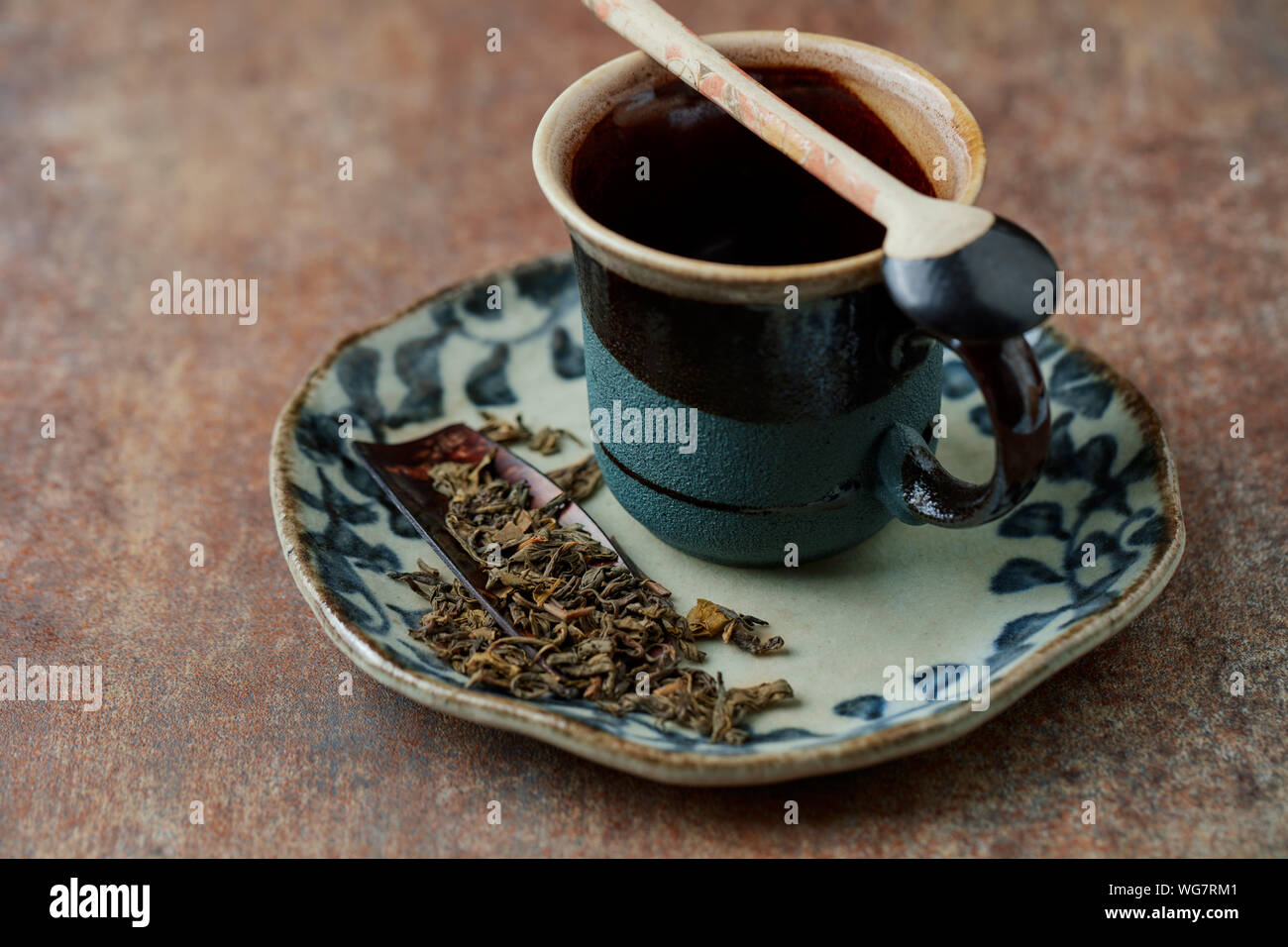 Empty Ceramic Tea Cup and Green Tea Leaves. Symbolic image. Asian ...