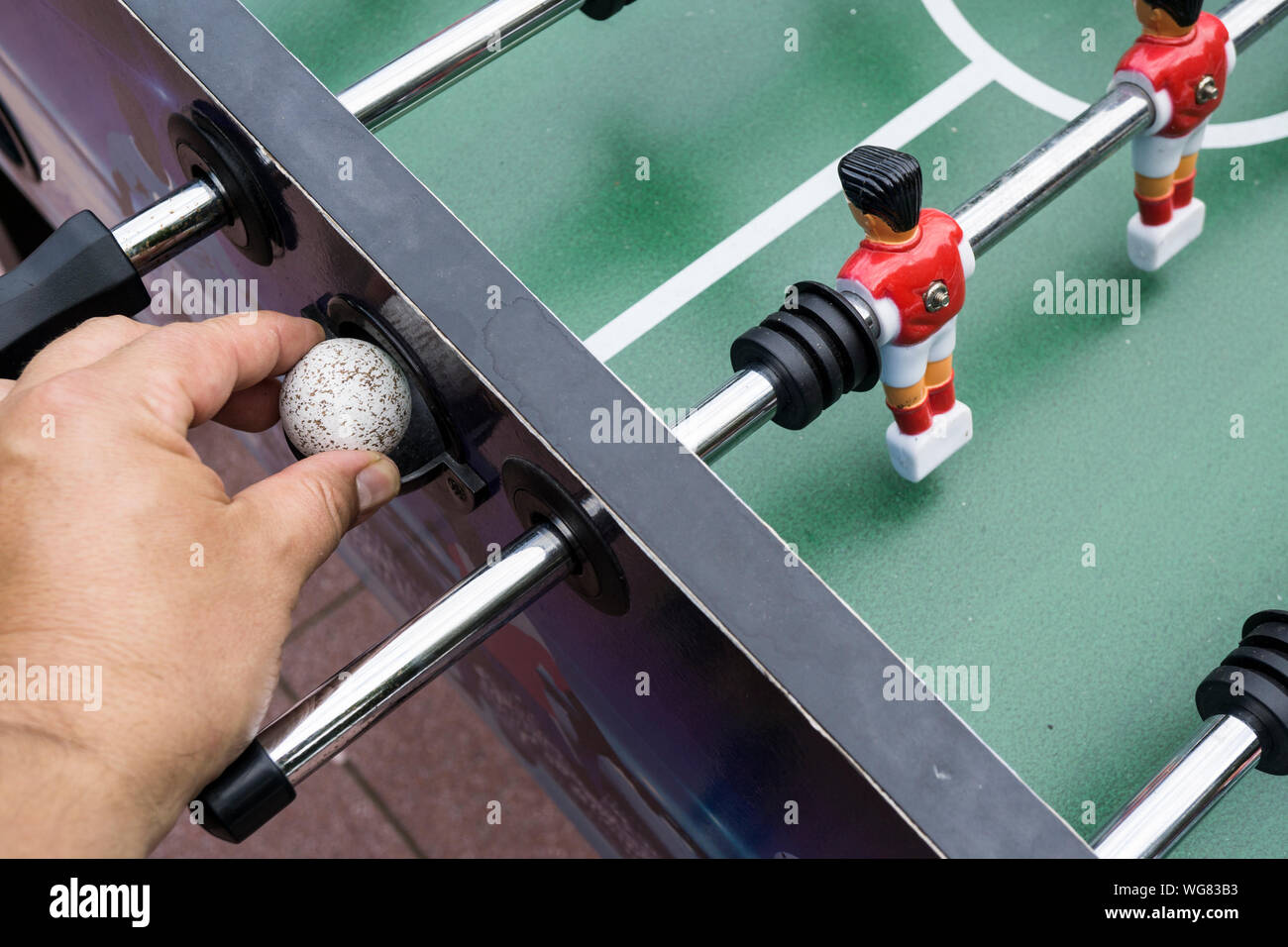 Hand and foosball table hi-res stock photography and images - Alamy