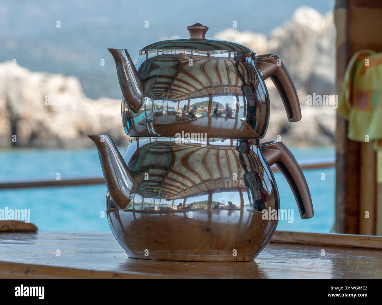 Two turkish teapots sit on wooden table on boat Stock Photo - Alamy