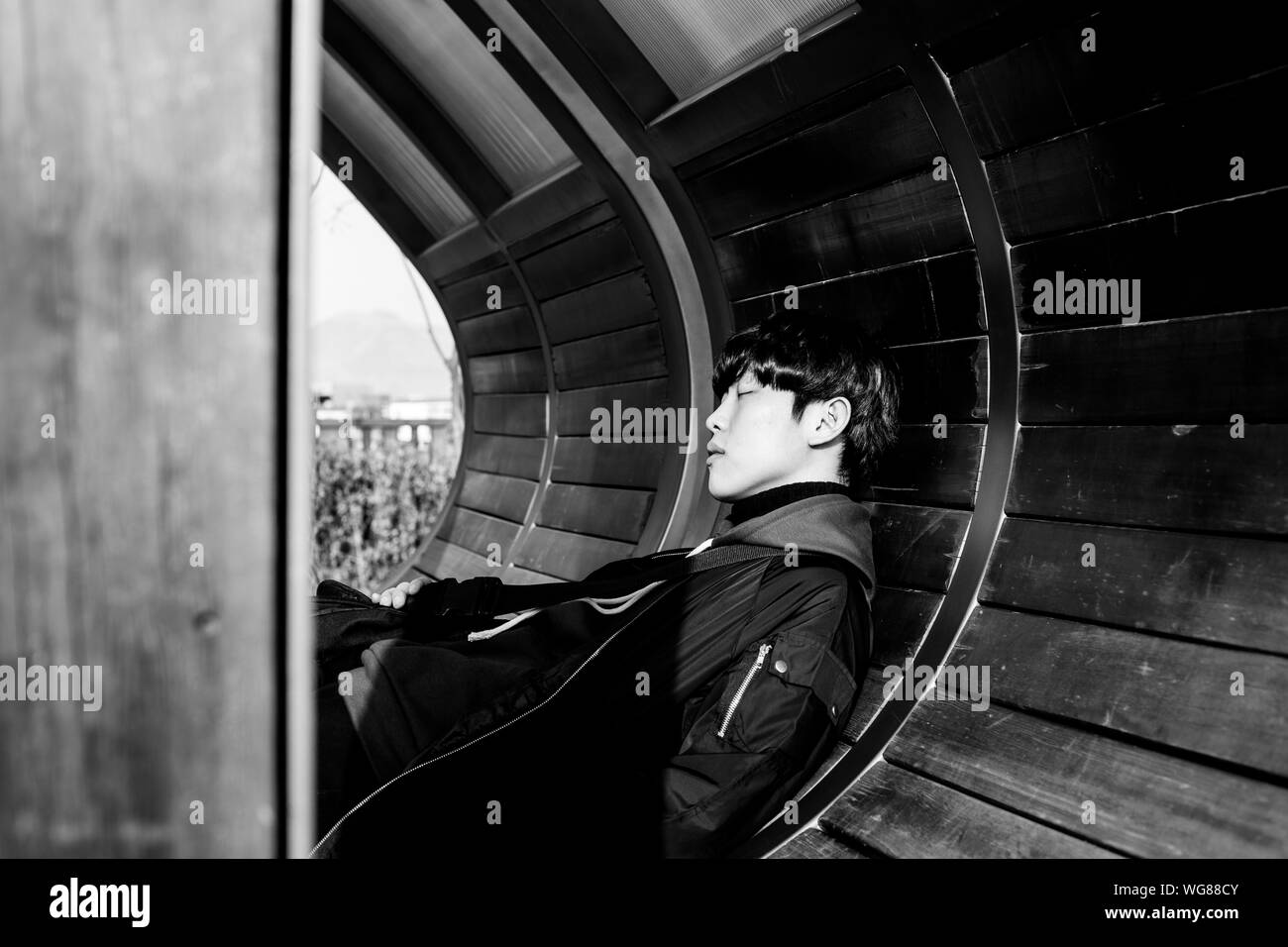 Young man sleeping on bench hi-res stock photography and images - Alamy
