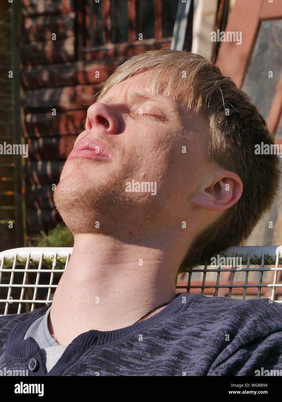 Man sleeping in chair hi-res stock photography and images - Alamy