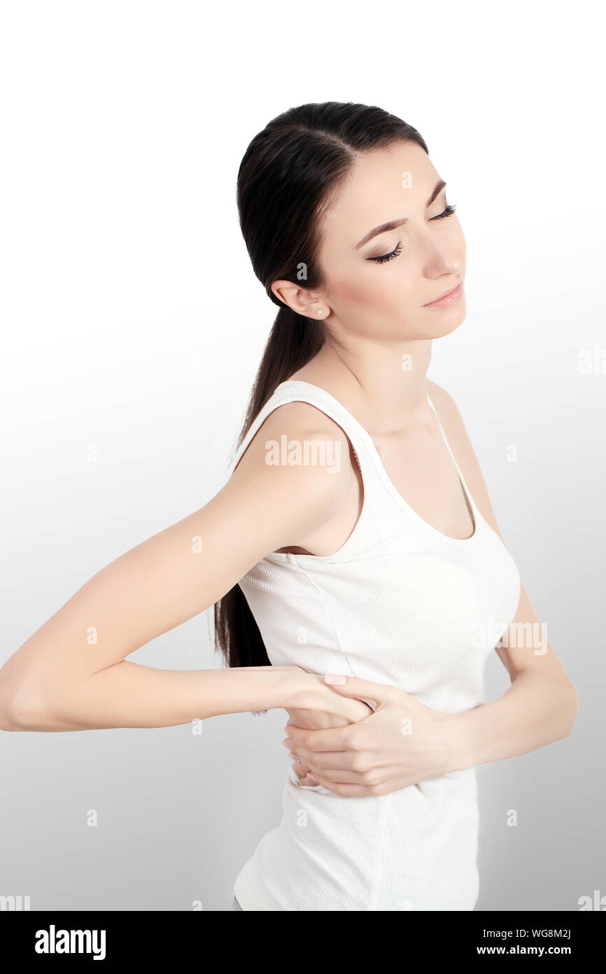 Woman touching painful back/spine. Pain in a woman back - healthcare ...