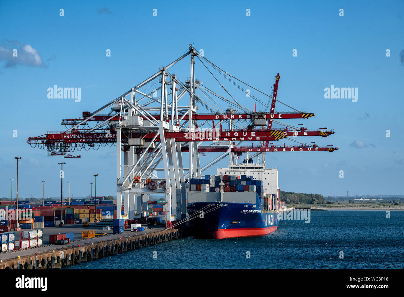 The port of Dunkerque in Northern France. Cranes load container ships ...