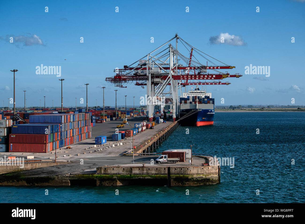 The port of Dunkerque in Northern France. Cranes load container ships ...