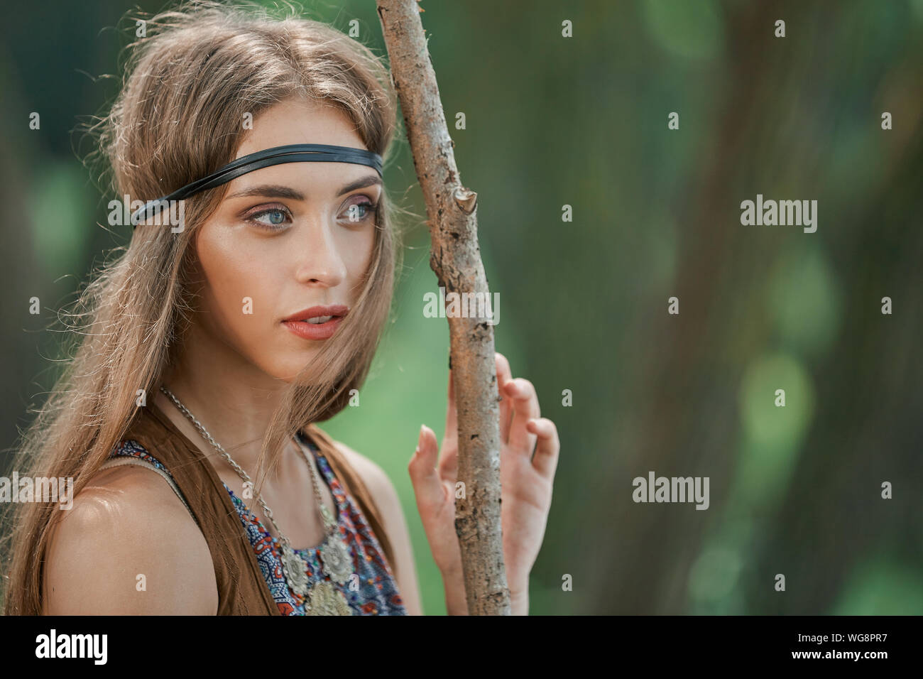 portrait of a beautiful woman hippies in a forest . the concept of ...