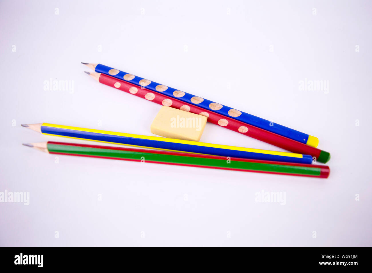 colored pencils with eraser to erase on a white background, there is ...