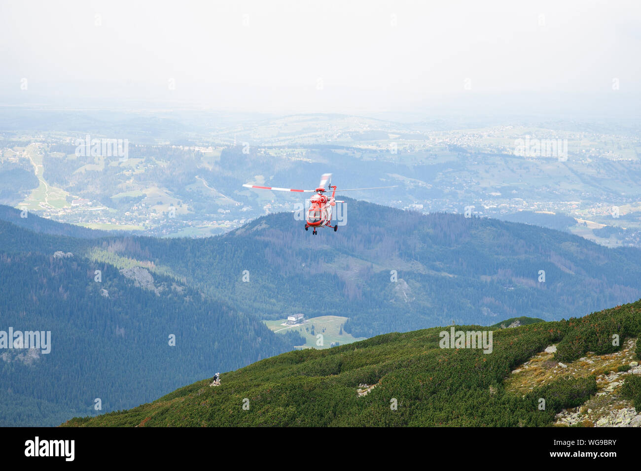Helicopter flying over mountains hi-res stock photography and images ...
