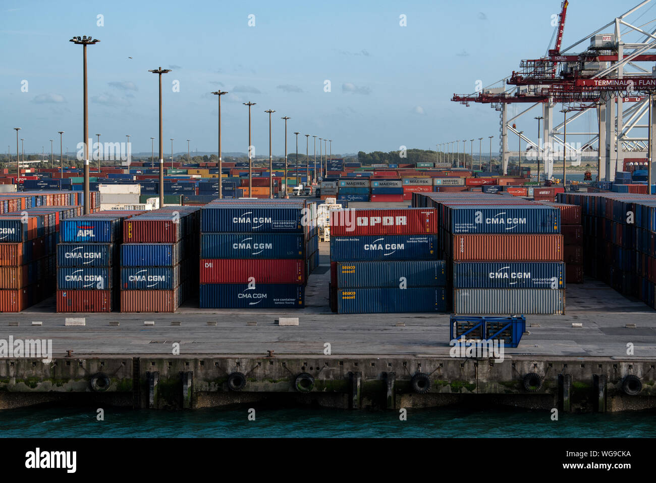The port of Dunkerque in Northern France. Cranes load container ships ...