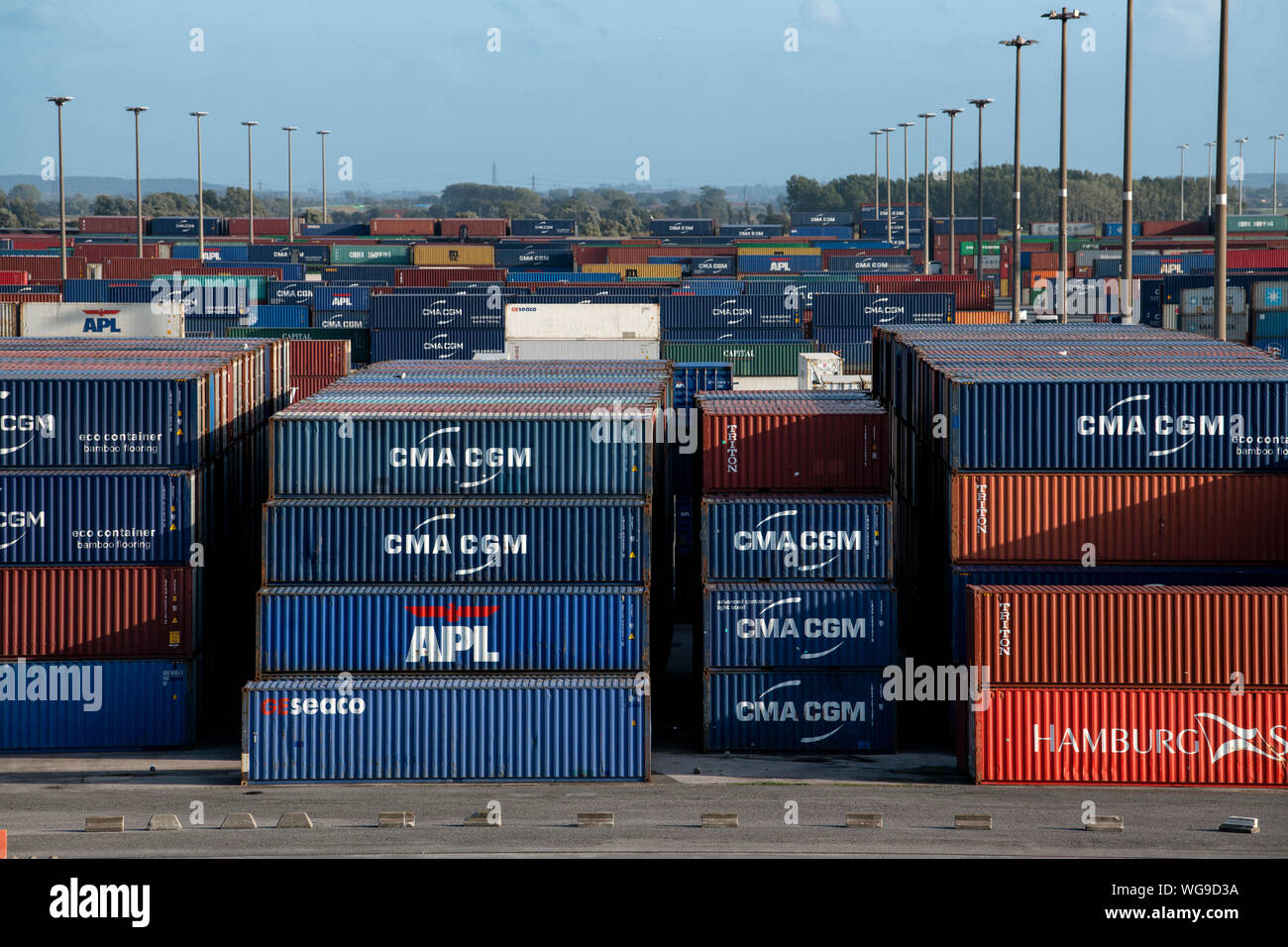 The port of Dunkerque in Northern France. Cranes load container ships ...