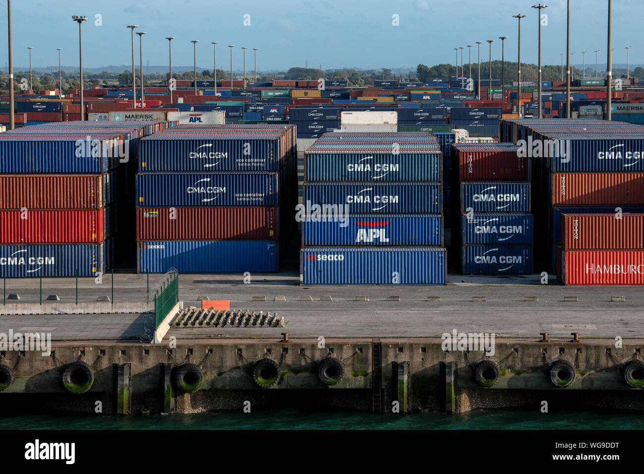 The port of Dunkerque in Northern France. Cranes load container ships ...