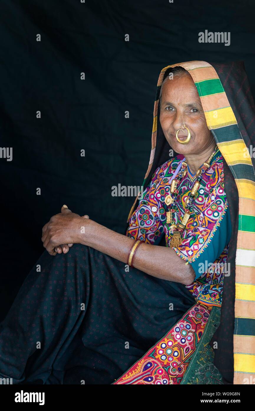 Elderly Ahir woman in traditional colorful clothes with a nose ring ...